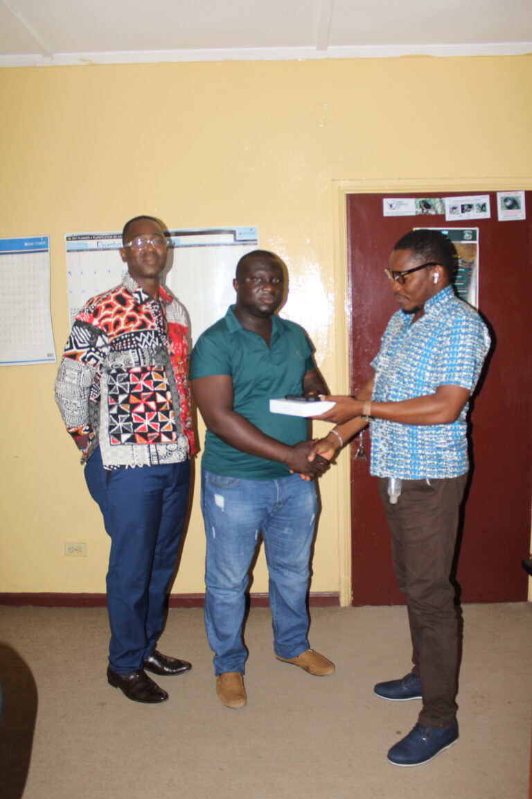 James K. Mulbah, SCNL Land Use Planning Coordinator receives a black ...