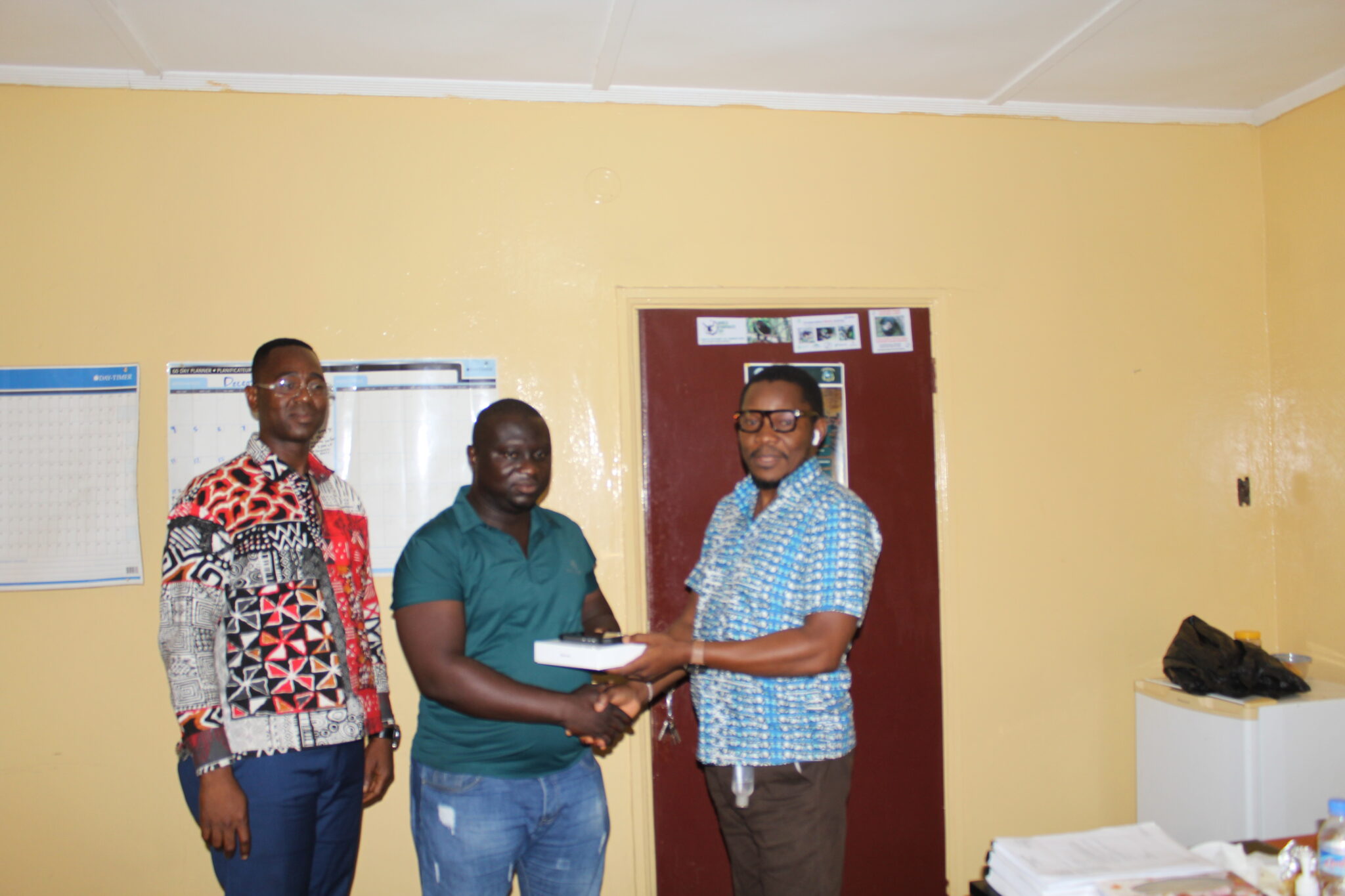 James K. Mulbah, SCNL Land Use Planning Coordinator receives a black ...